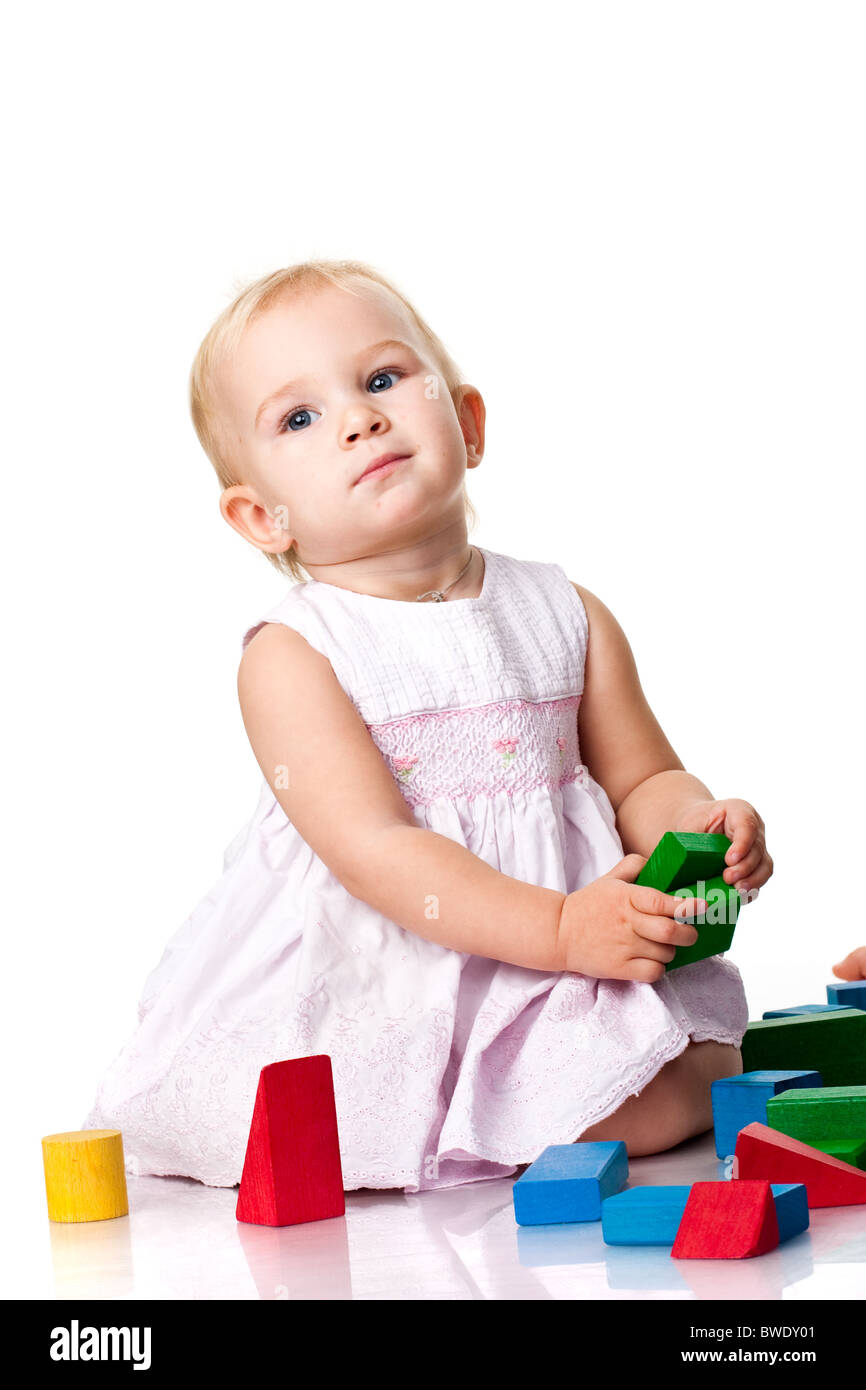 Beautiful baby building a castle with cubes isolated on white Stock ...