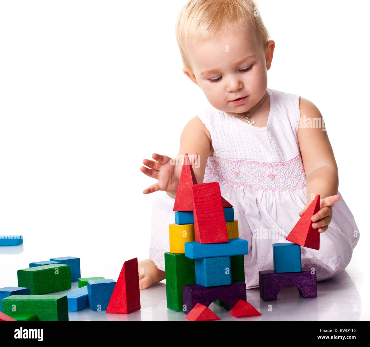 Beautiful baby building a castle with cubes isolated on white Stock ...
