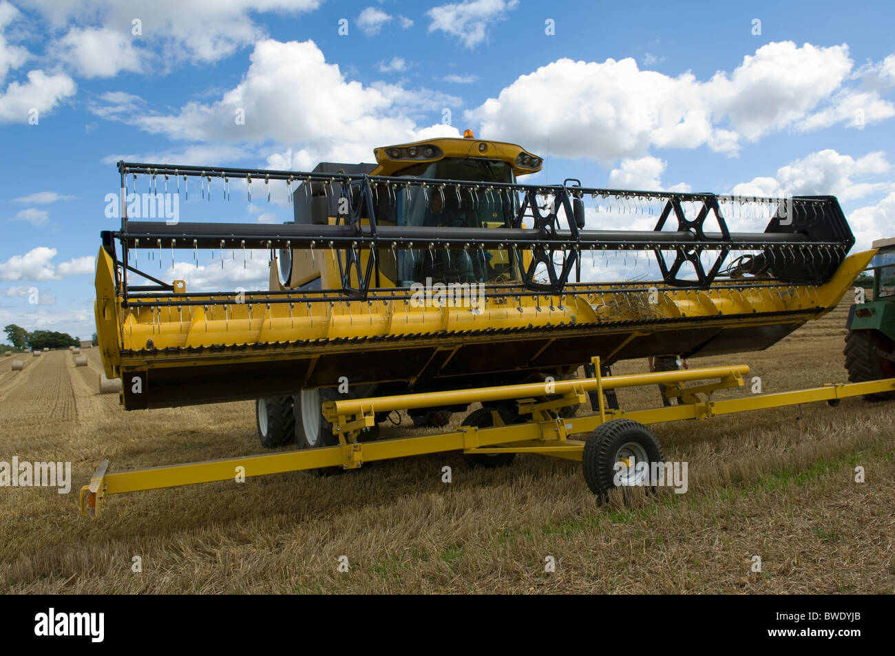 Combine harvester unloading header Stock Photo - Alamy