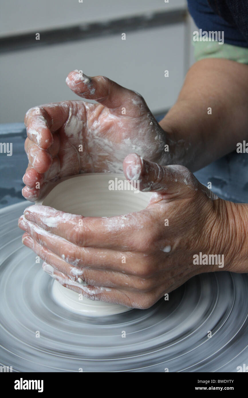 Hands of a female potter throwing a porcelain pot on a wheel Stock ...