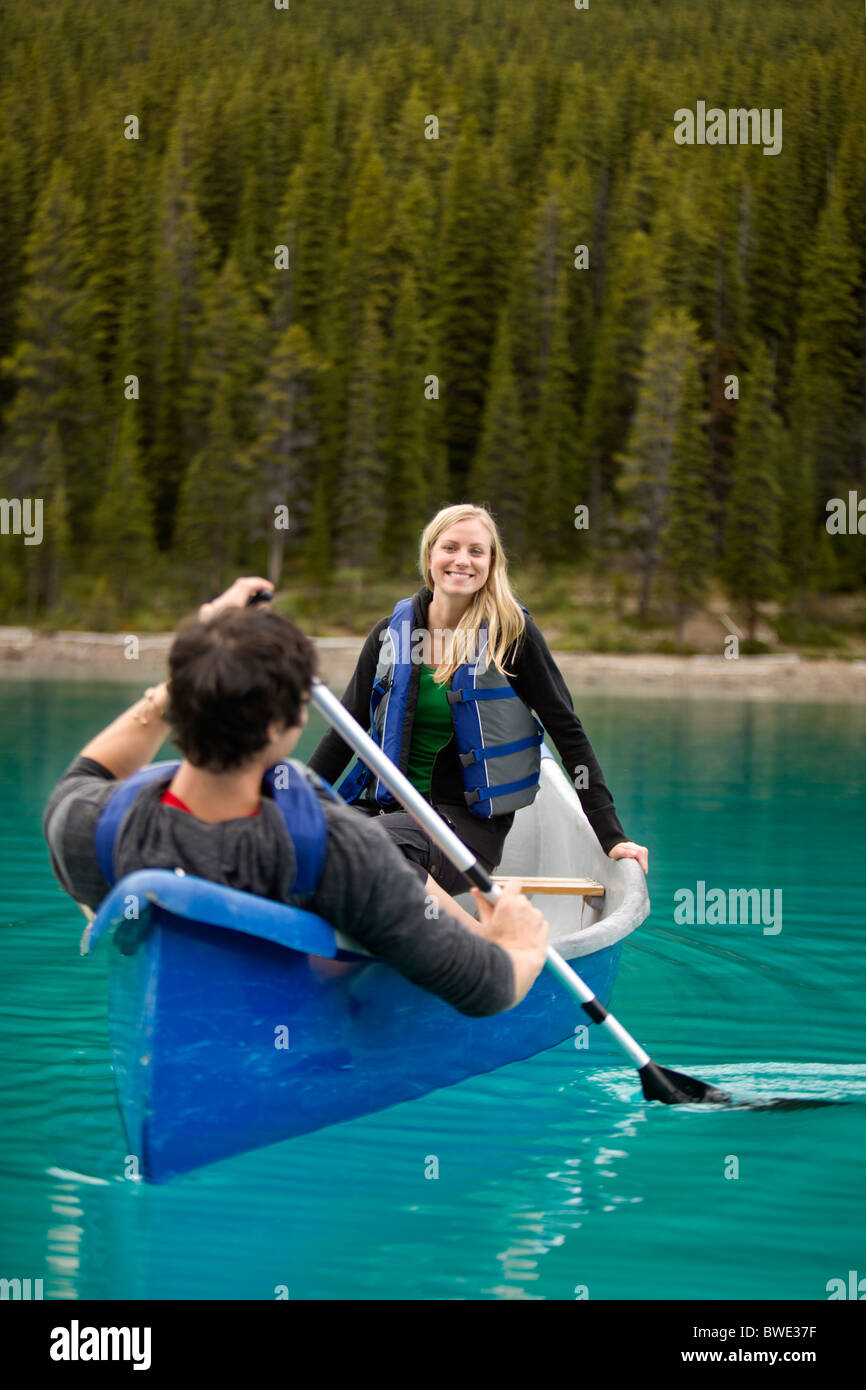 A happy couple canoeing on a glacial lake Stock Photo - Alamy