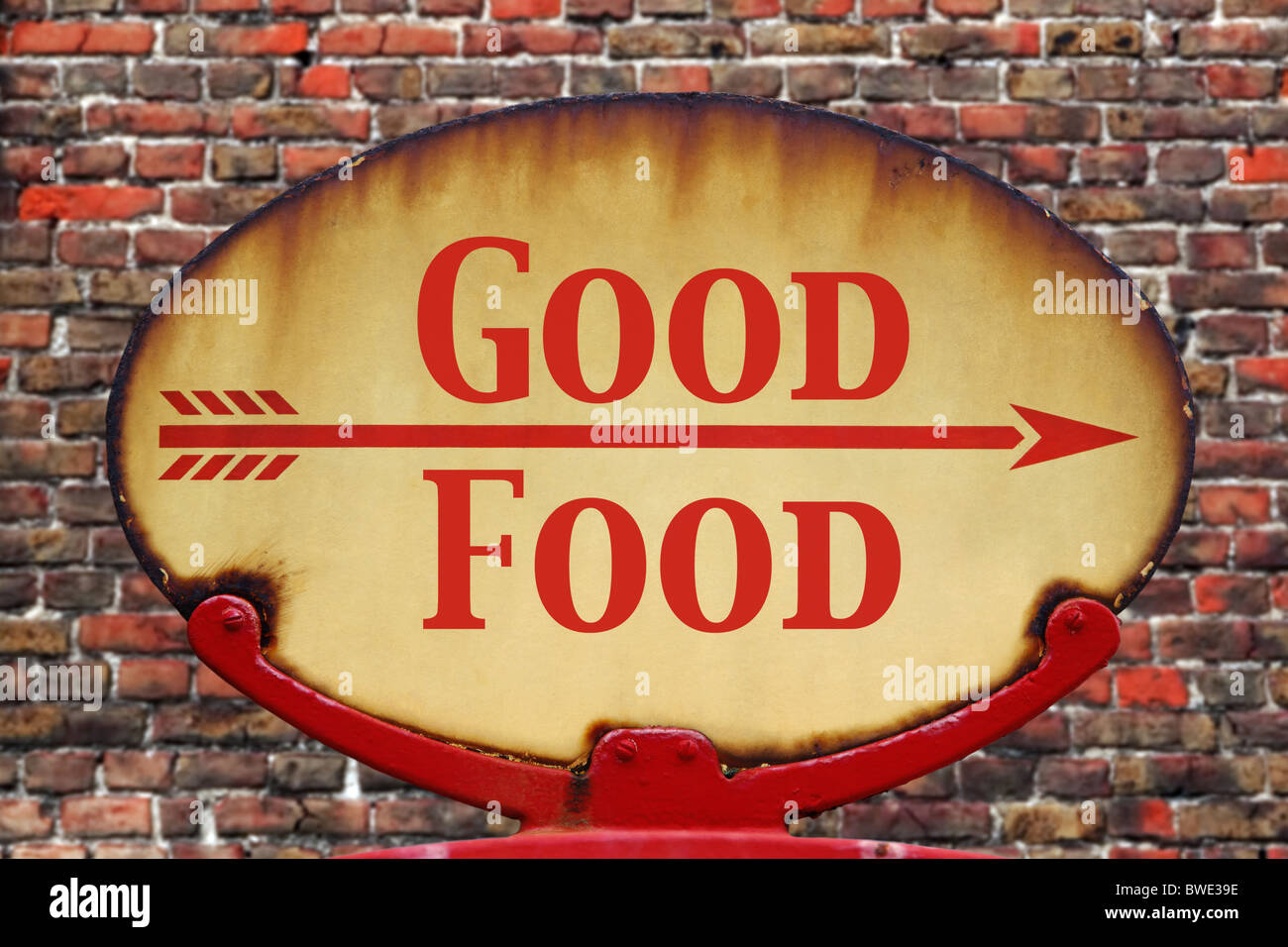 A rusty old retro arrow sign with the text Good Food Stock Photo - Alamy