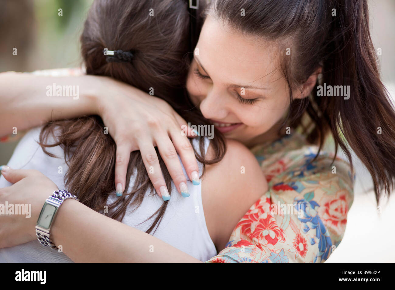 Young women hugging Stock Photo - Alamy