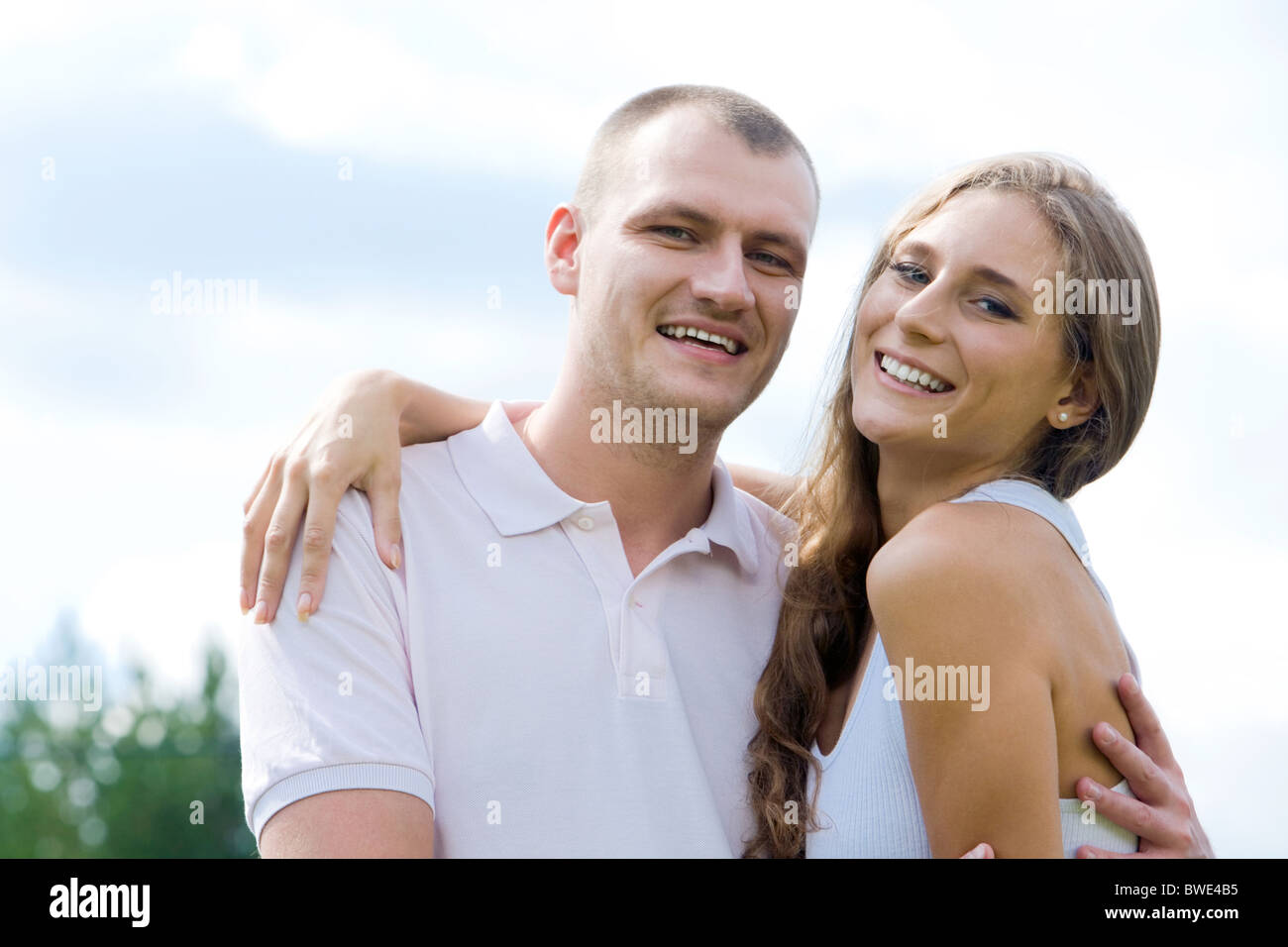Smiling female and her husband embracing each other Stock Photo - Alamy