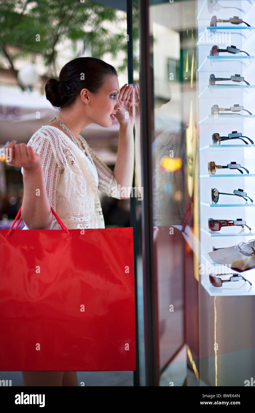 Young female customer examining merchandise hi-res stock photography ...