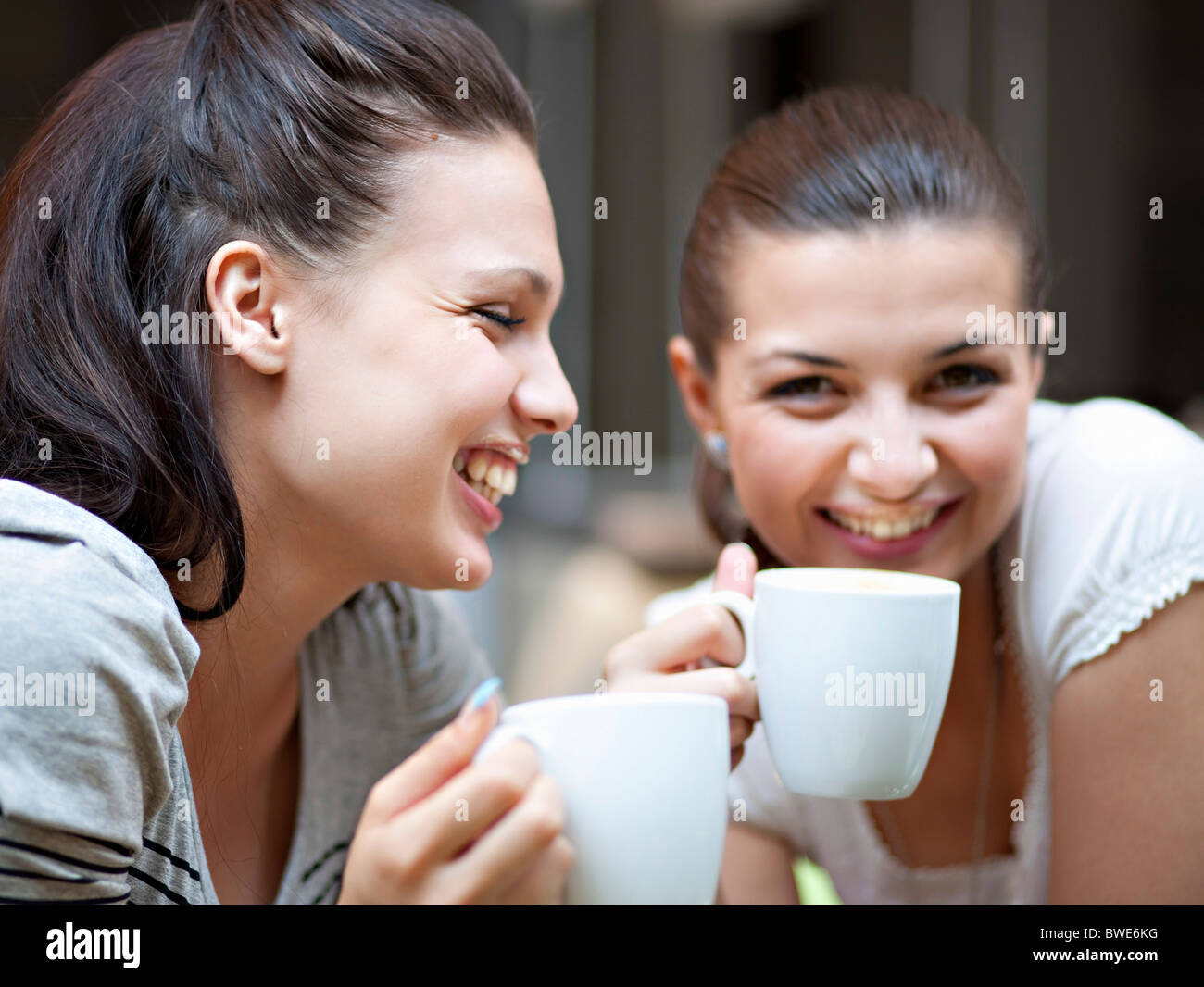 Young women having coffee Stock Photo - Alamy