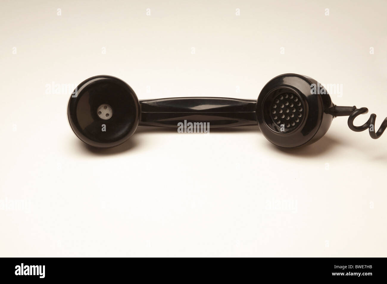 black old bt telephone on white background close up detail of hand set ...