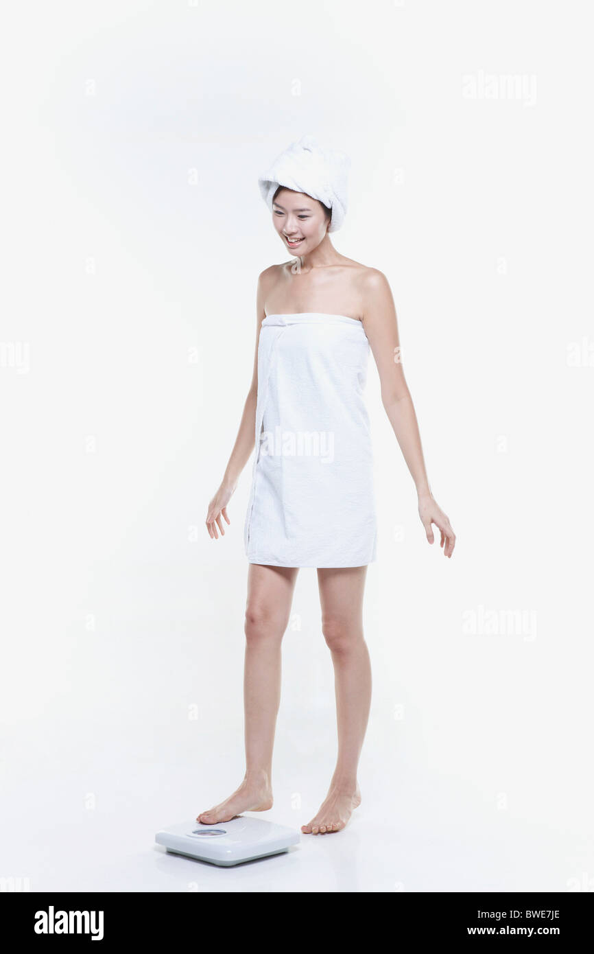 woman in a towel measuring her weight Stock Photo - Alamy