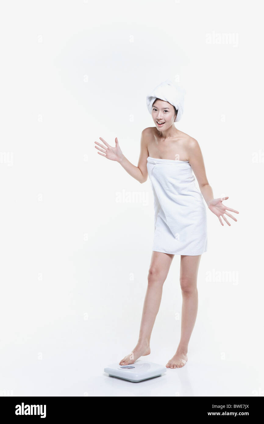 woman in a towel measuring her weight Stock Photo - Alamy