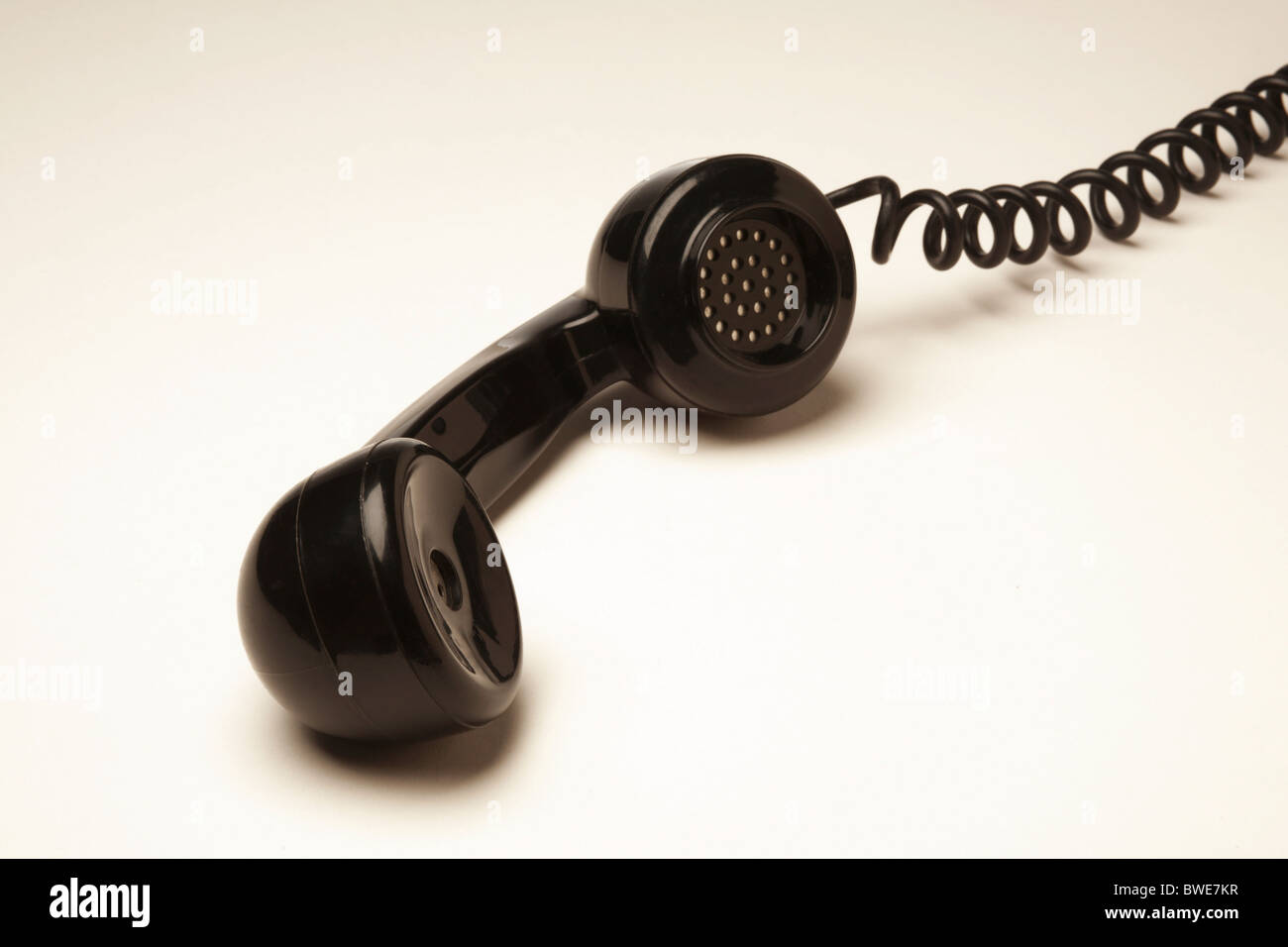black old bt telephone on white background close up detail of hand set ...