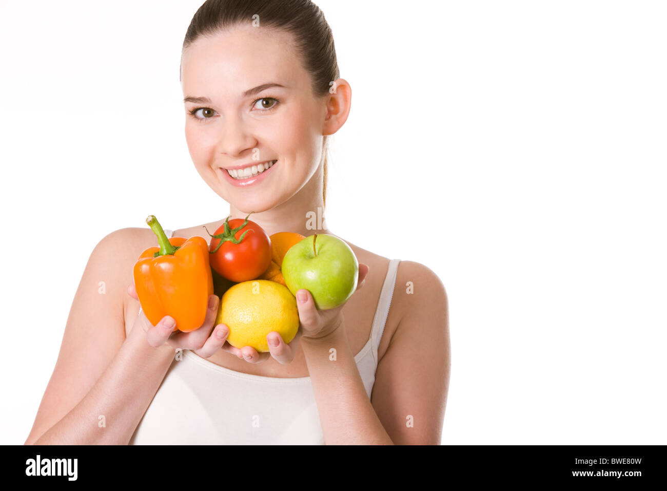 Portrait of pretty girl holding different fruits and vegetables in ...