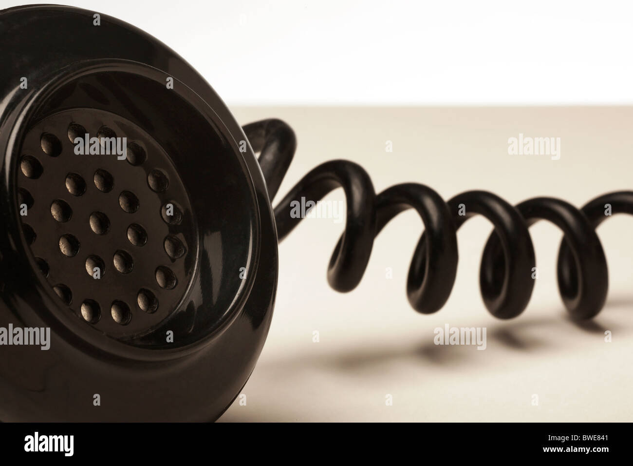 black old bt telephone on white background close up detail of hand set ...