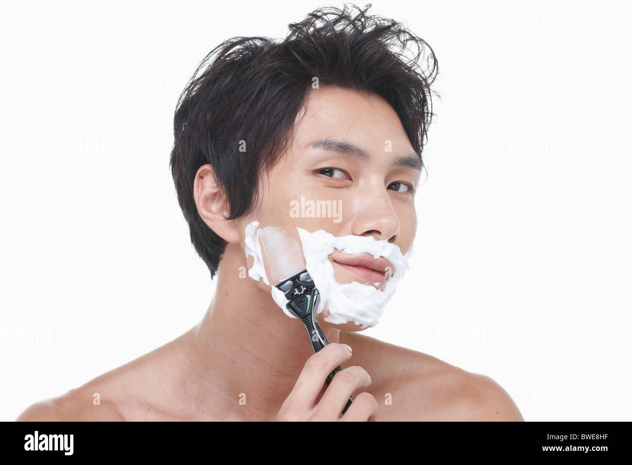 guy is shaving his face with razor Stock Photo - Alamy