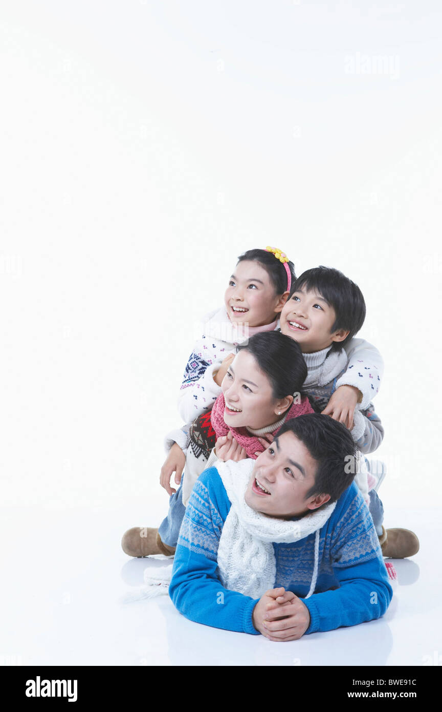 family members sitting in a row with smile Stock Photo - Alamy