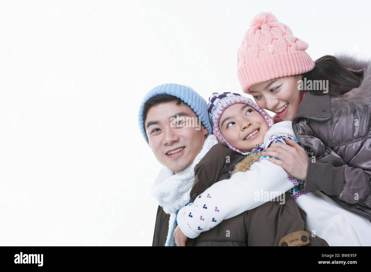 parents and daughter hugging each other Stock Photo - Alamy