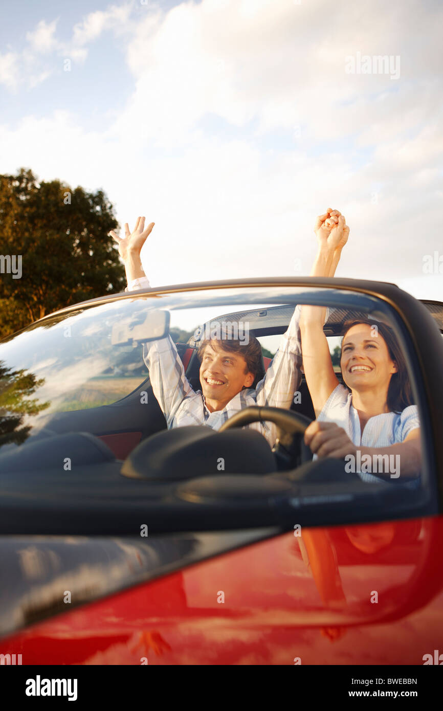 Couple in an electric sports car, fun Stock Photo - Alamy