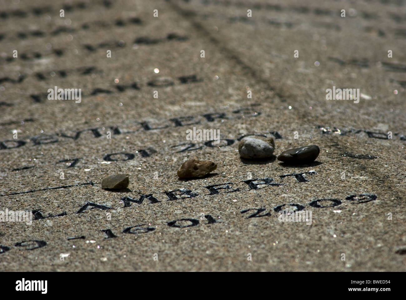 Tribute stones on a tombstone on Montparnasse cemetery Stock Photo - Alamy