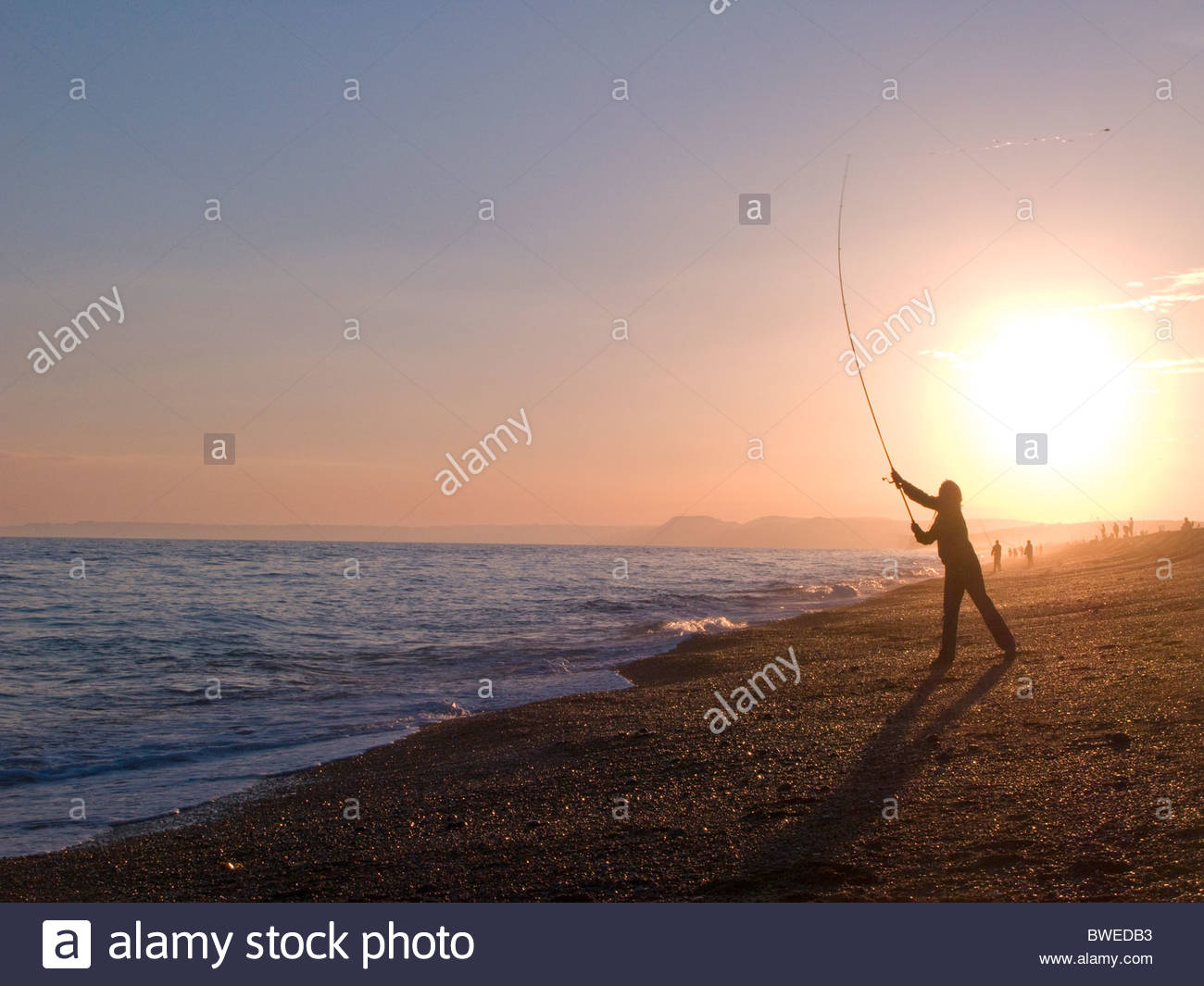 Silhouette Man Casting Fishing Rod Stock Photos & Silhouette Man ...