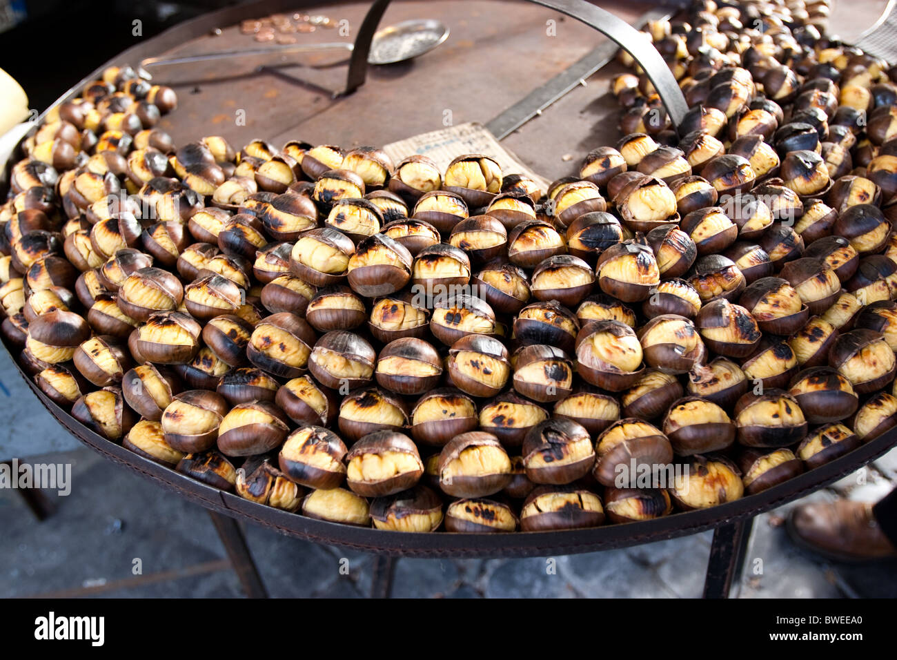 Roasted chestnuts in street Rome Italy Europe cooked on grill spot Roma ...