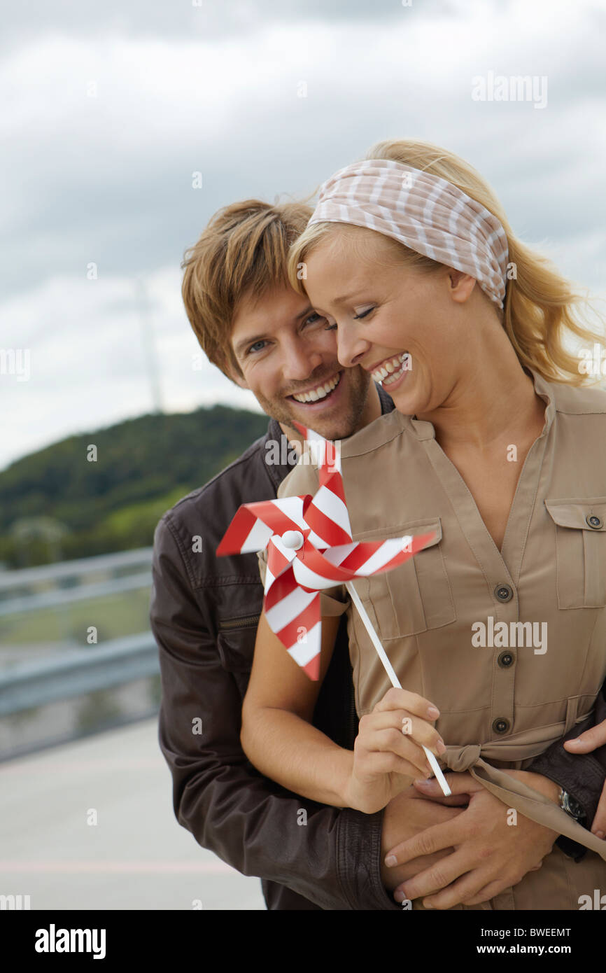 Couple holding handheld windmill Stock Photo - Alamy