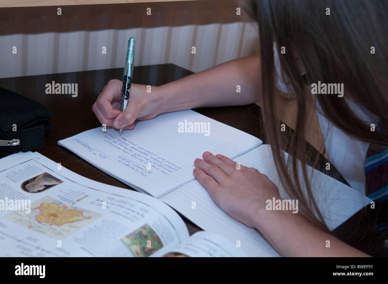 Young girl doing her homework in school uniform Stock Photo - Alamy