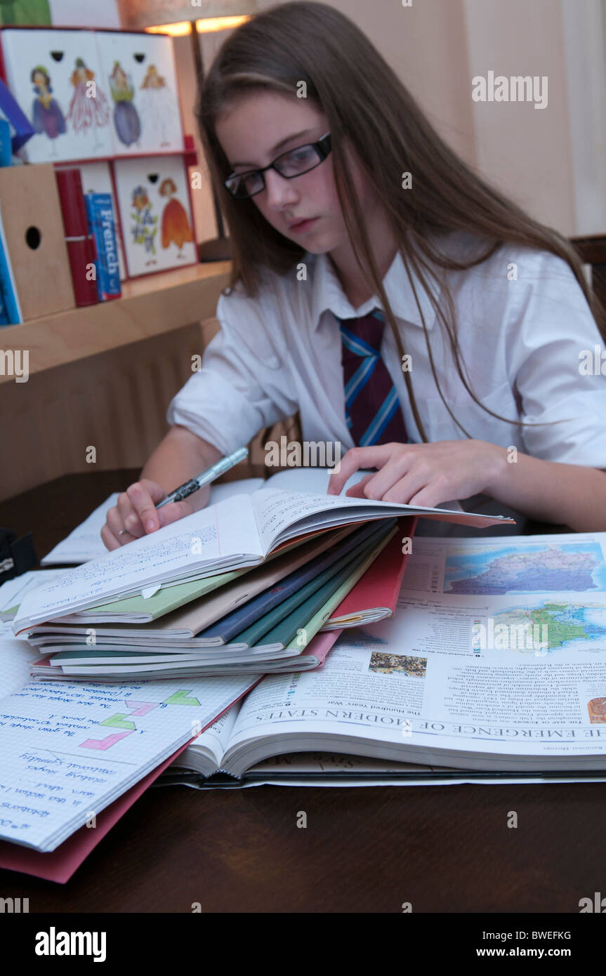 Young girl doing her homework in school uniform Stock Photo - Alamy