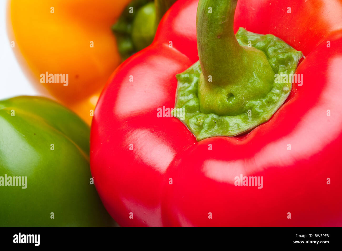 Macro shot of colorful bell peppers isolated on white Stock Photo - Alamy