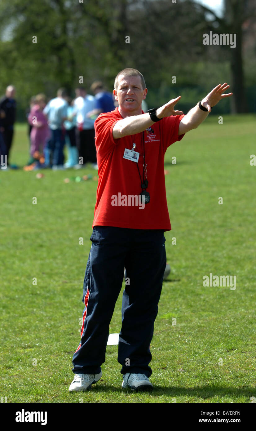 A coach demonstrates and gives instructions to one of his players Stock ...