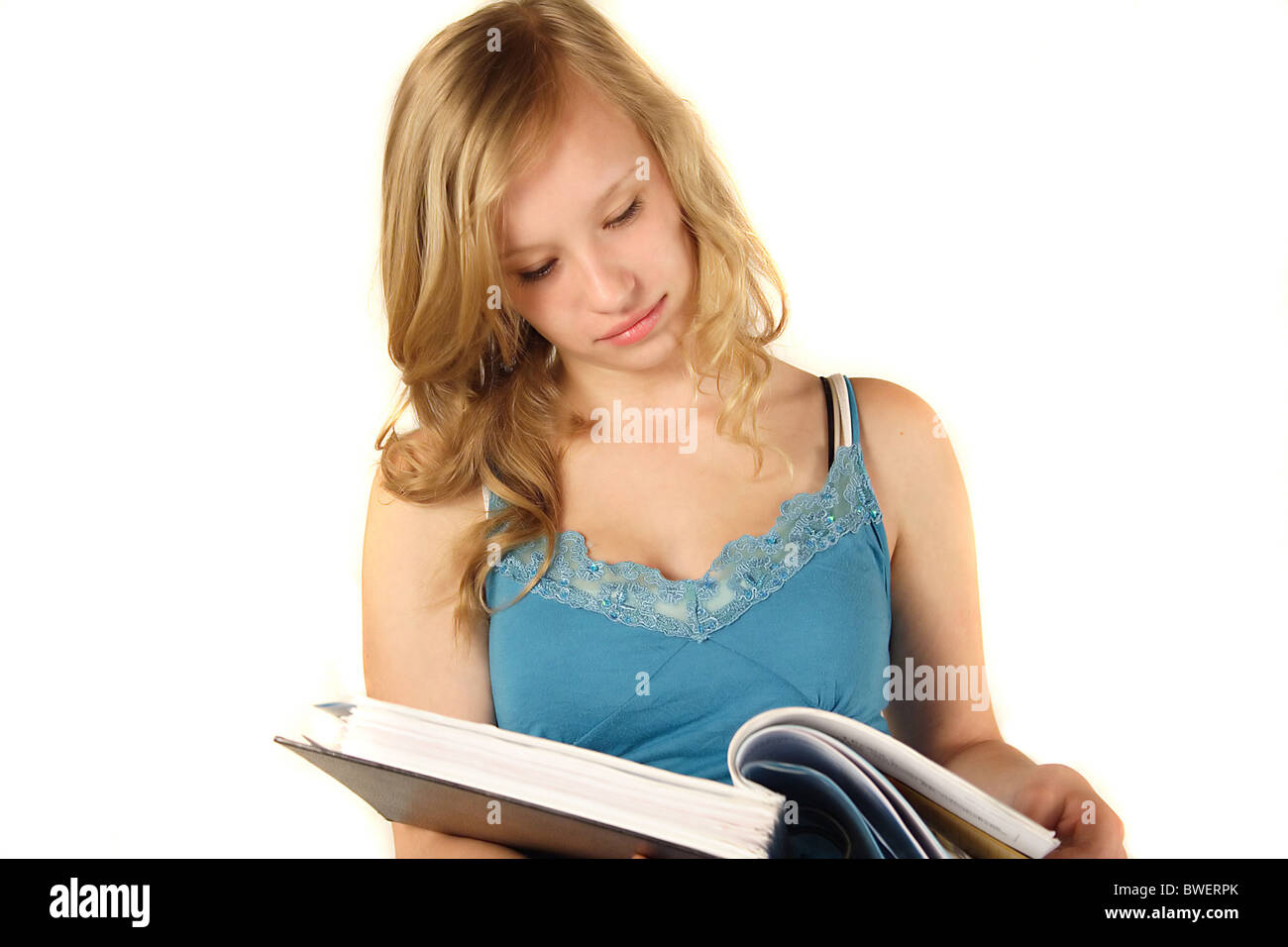 A young ambitious student reading. All isolated on white background ...
