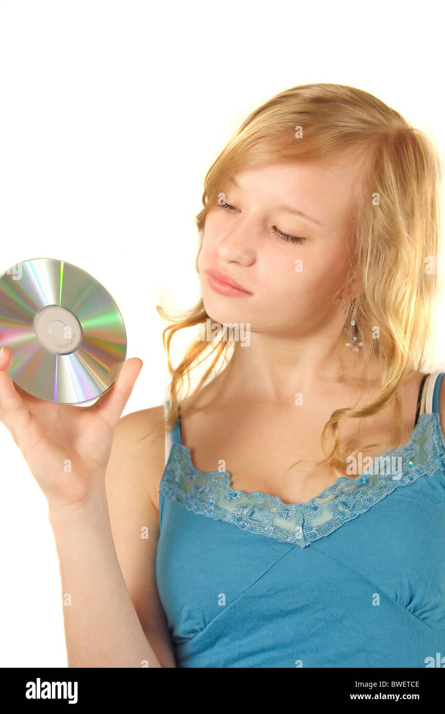 A young woman bending a cd or dvd. All isolated on white background ...