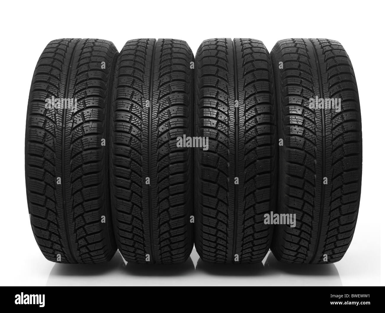 Set of four winter tires isolated on white background Stock Photo - Alamy