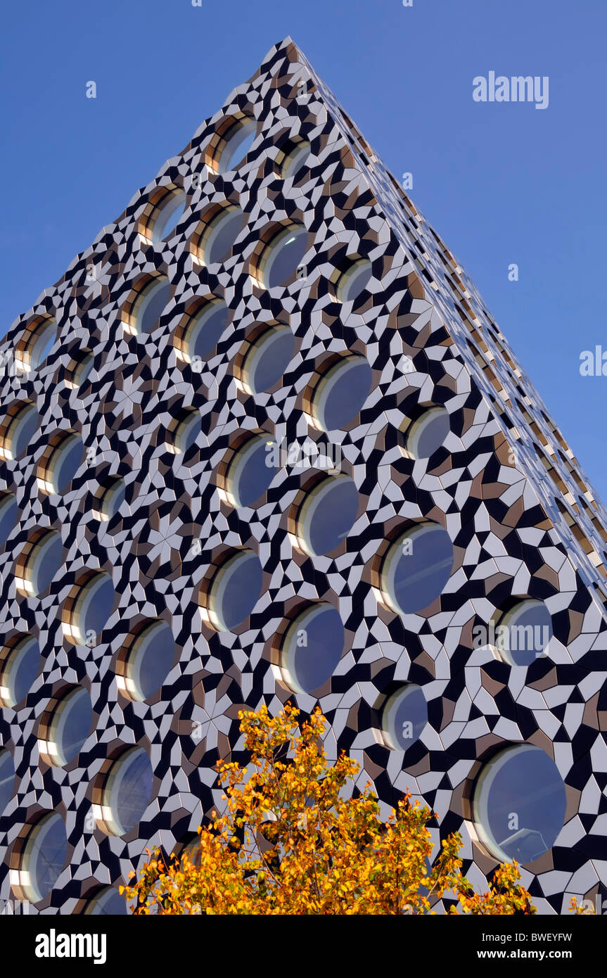 Autumn tree leaves with cladding on triangular facade on modern ...