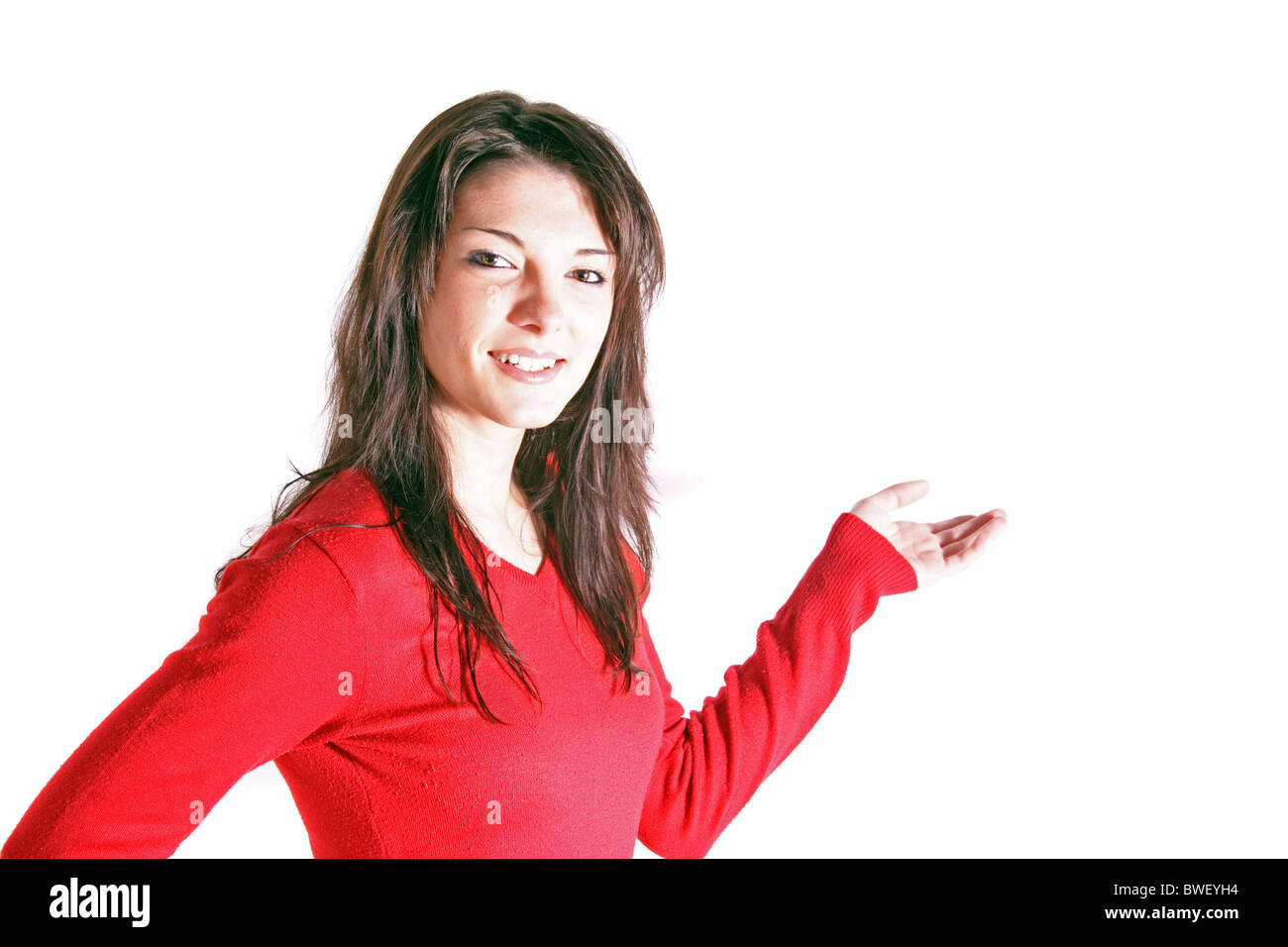 Attractive young woman pointing to the side. All on white background ...
