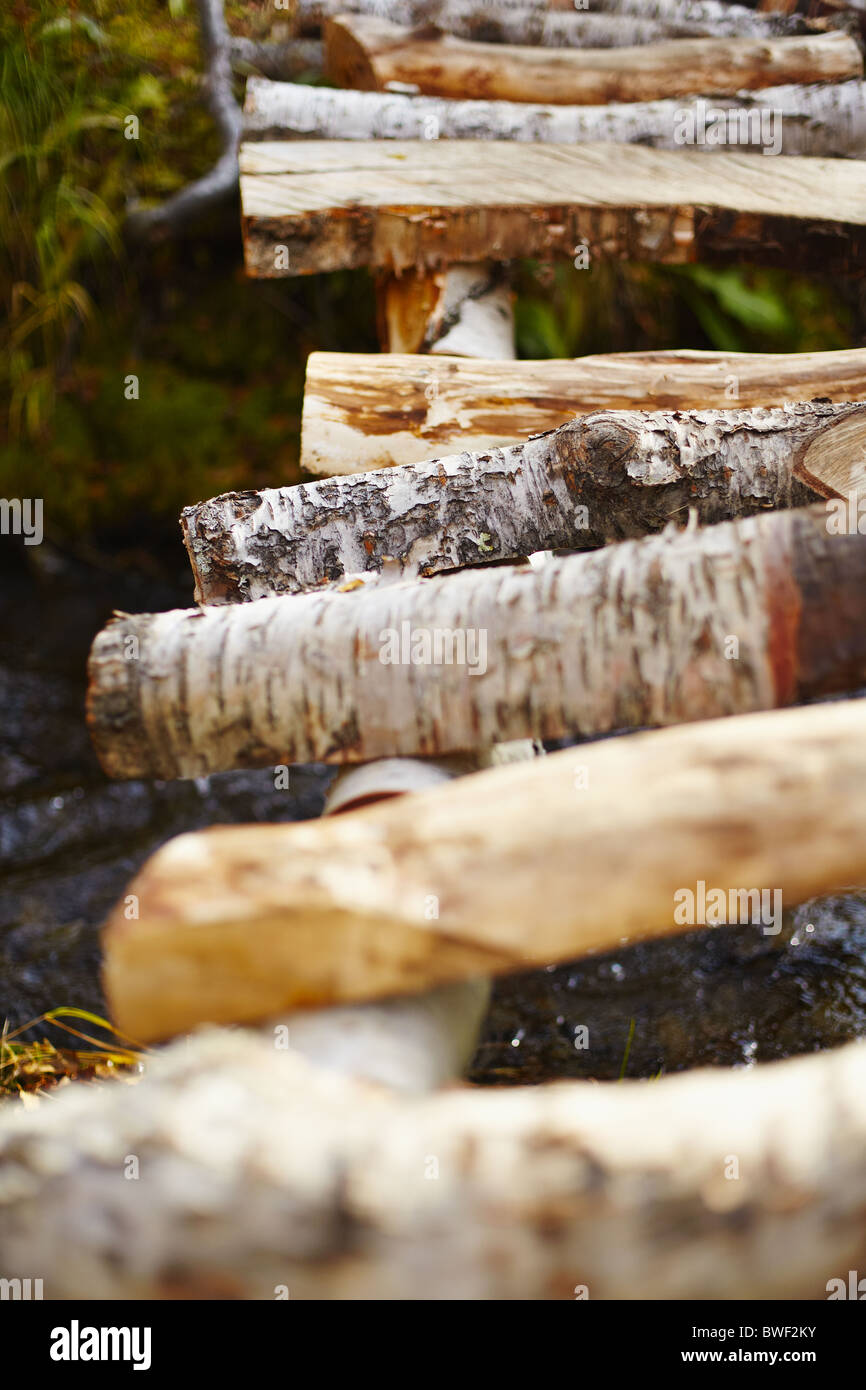 Wooden bridge over a stream close up Stock Photo - Alamy