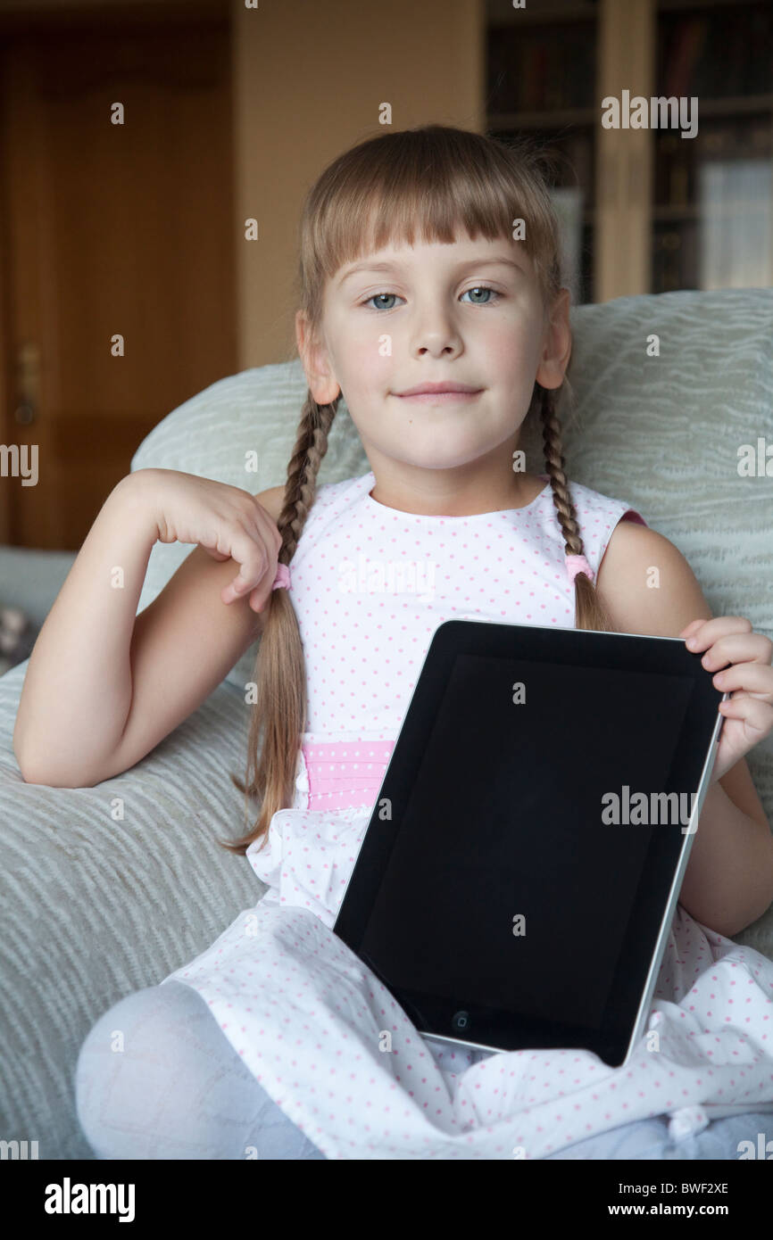 Little girl is using Apple iPad to draw and entertain herself at home ...