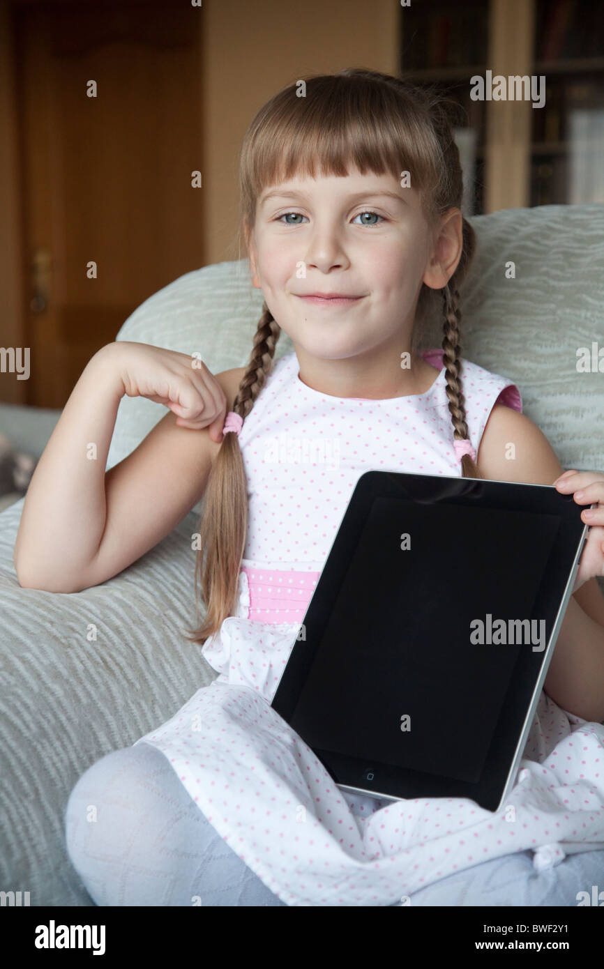 Little girl is using Apple iPad to draw and entertain herself at home ...
