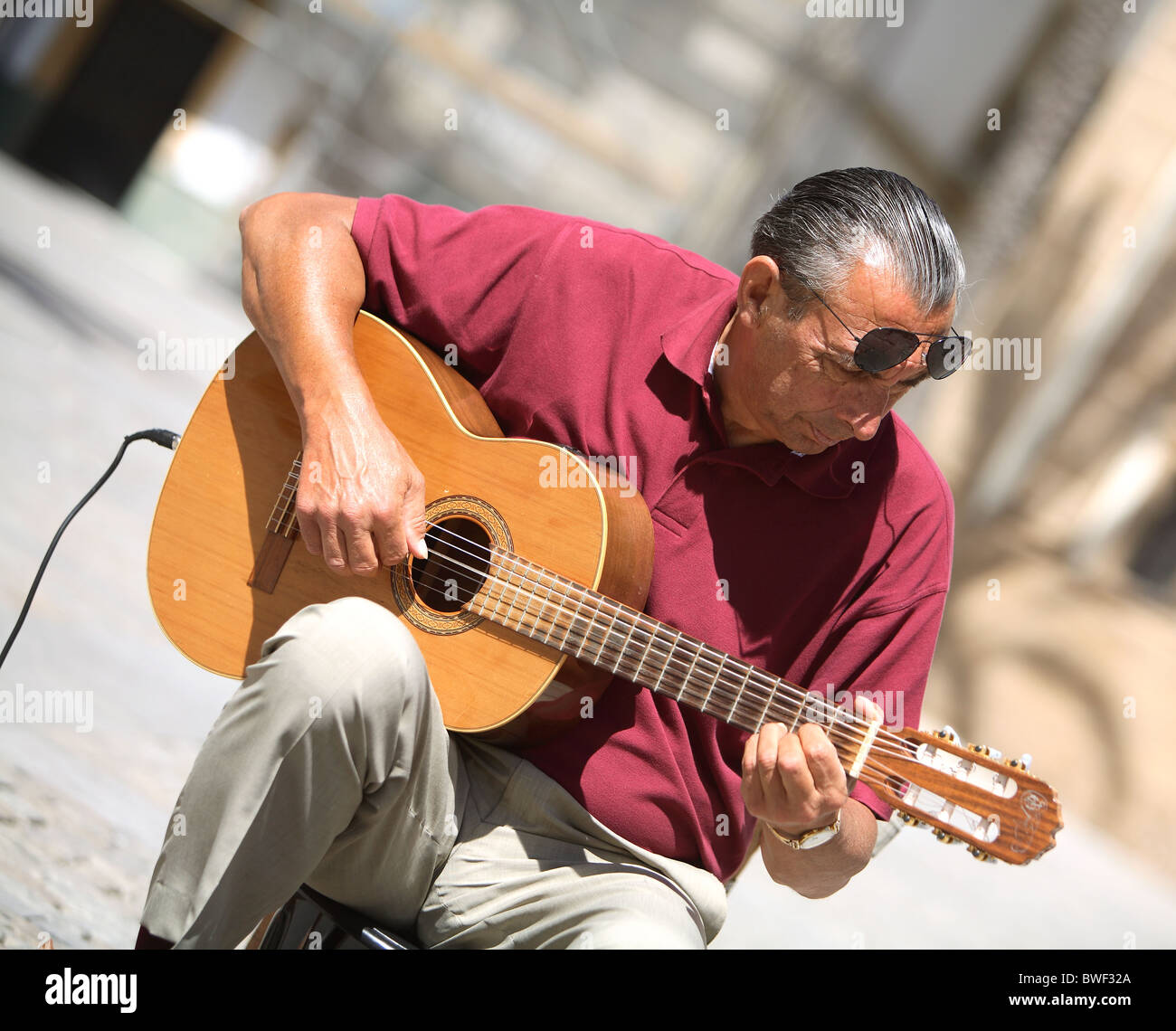 busker playing classical spanish guitar in the square in front of Cadiz ...