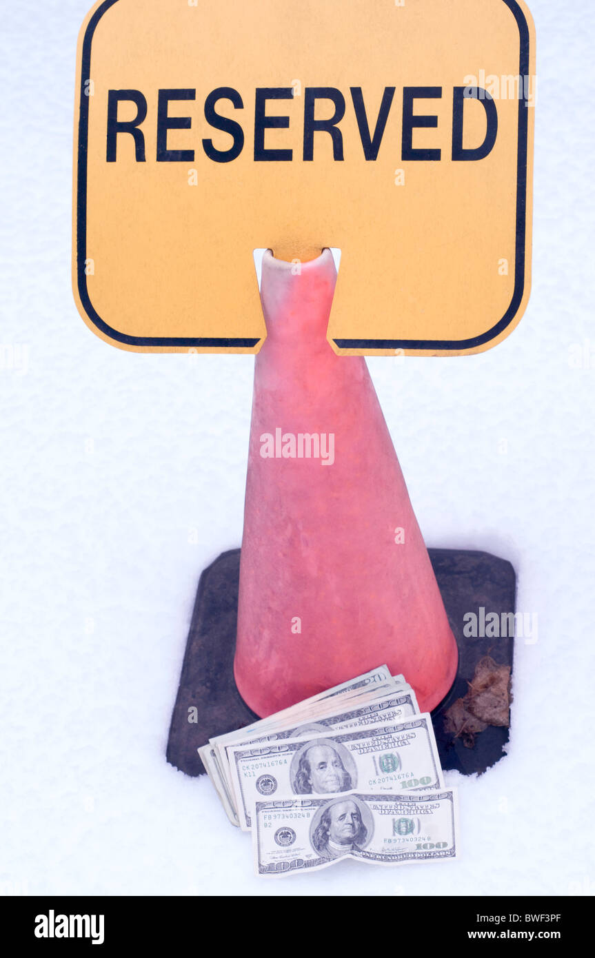 Paper money bills at the base of a reserved sign Stock Photo - Alamy