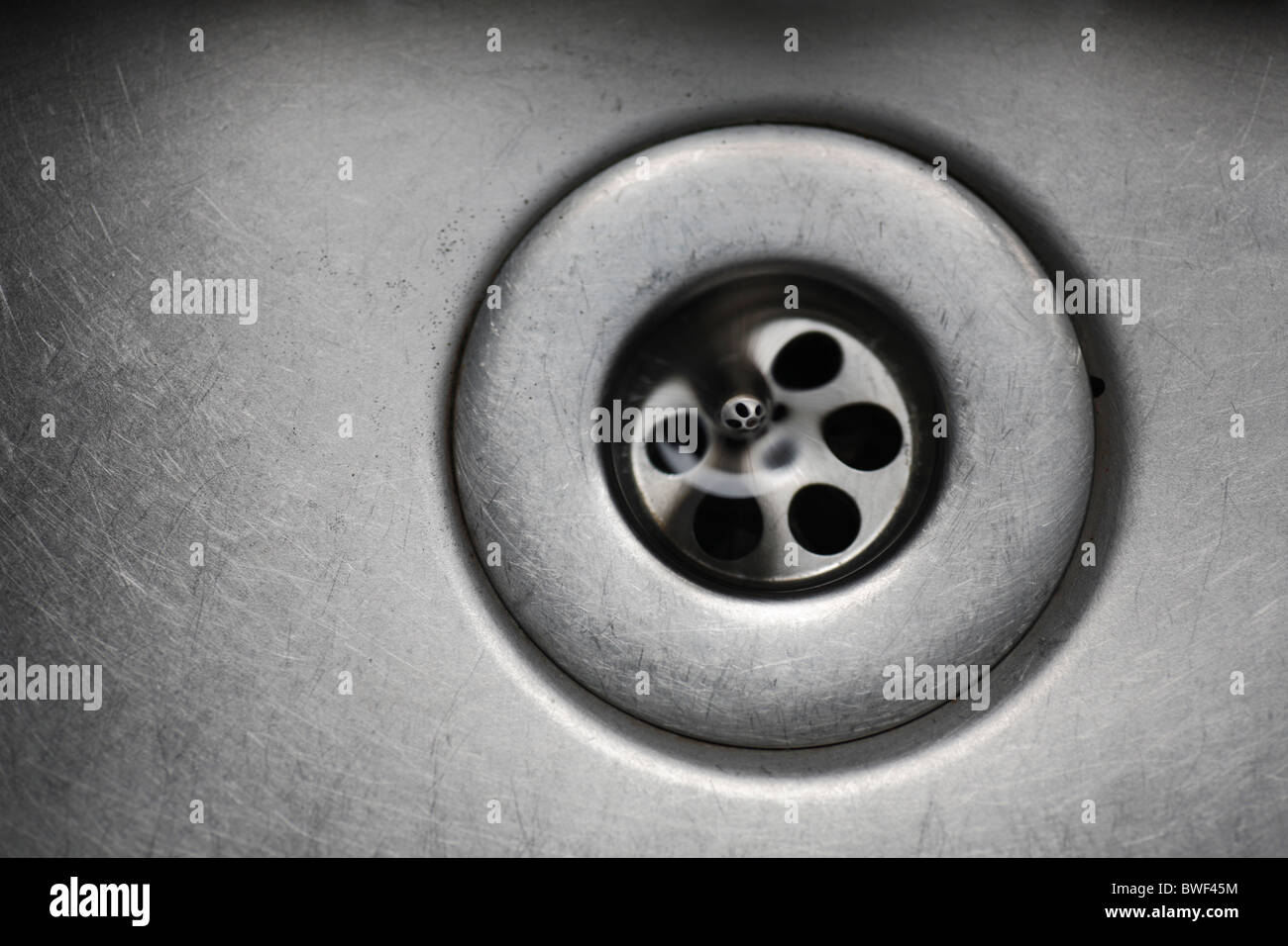 Water disappearing down the plug hole in a sink Stock Photo - Alamy