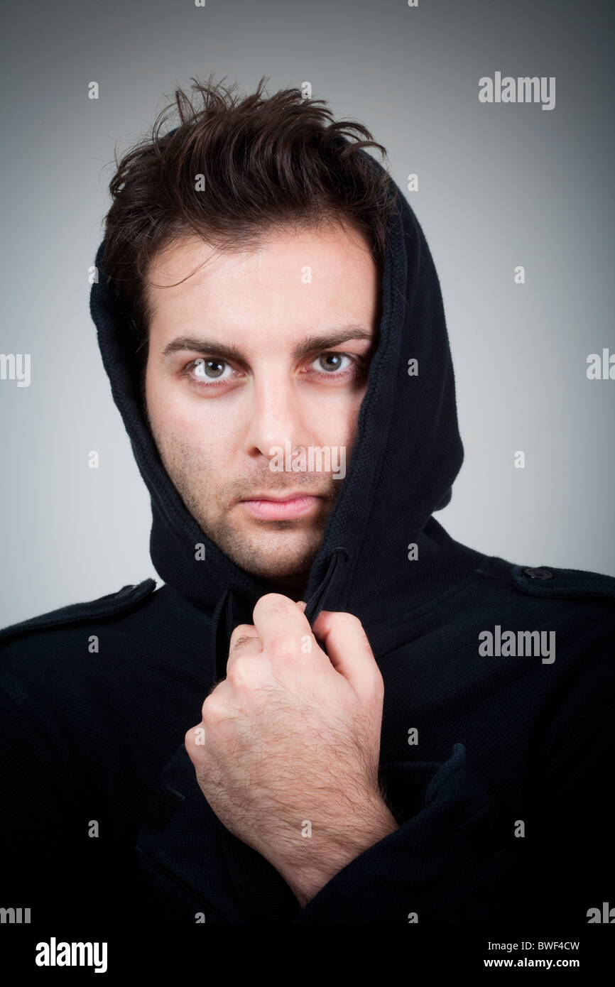 portrait of man in black top with hood looking at camera - isolated on ...