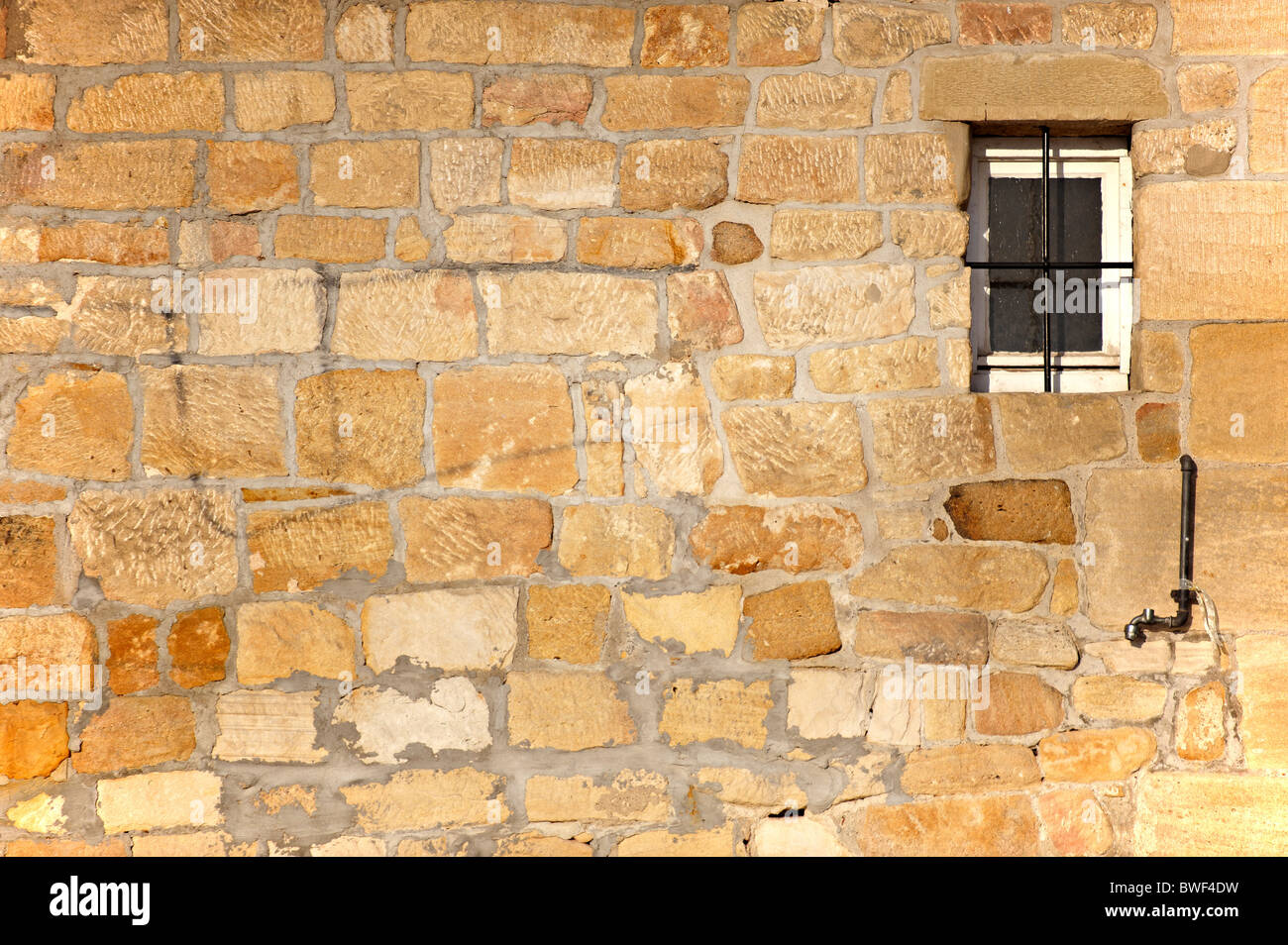 Stone wall with tap window and cleaned graffiti Stock Photo - Alamy