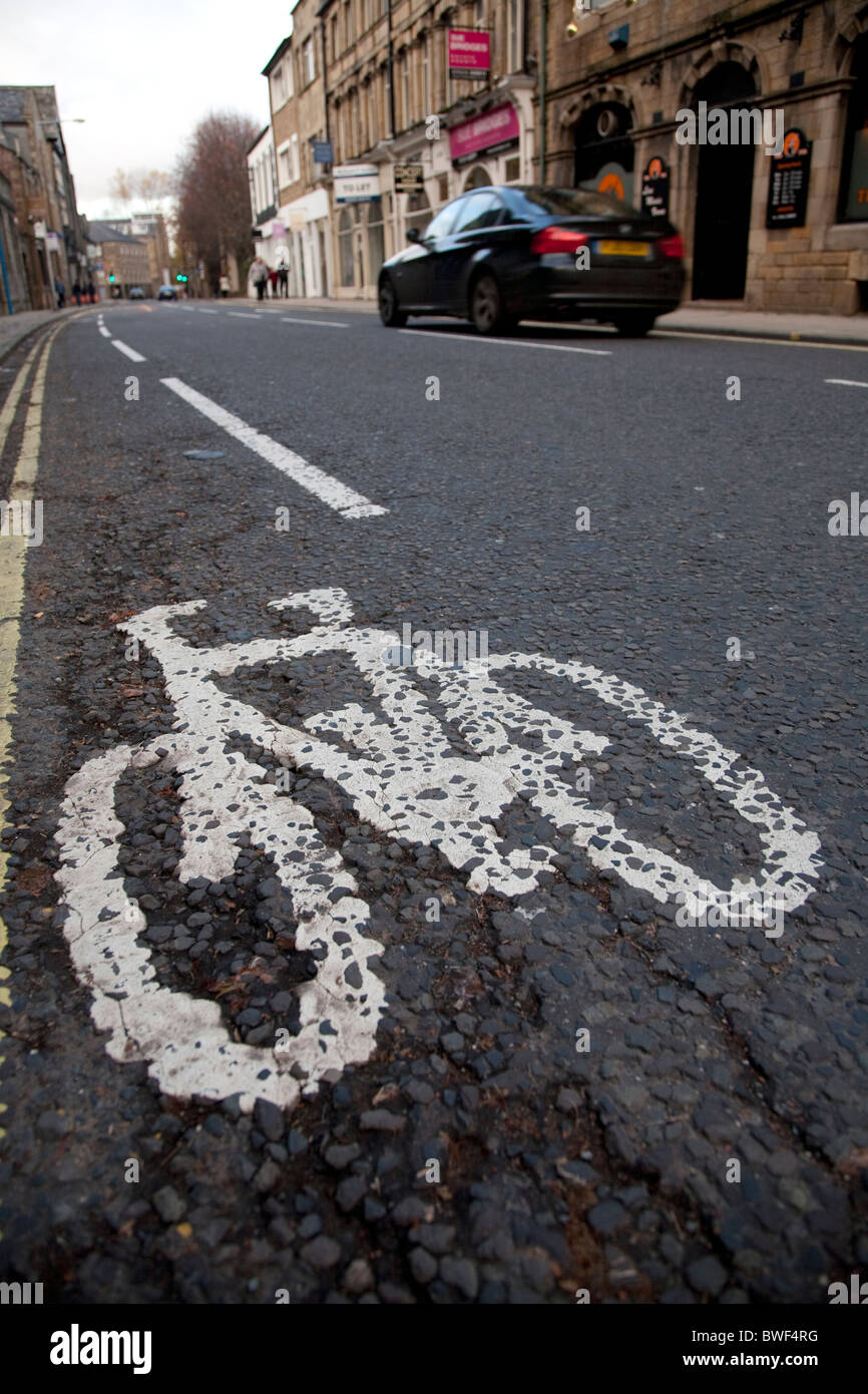 Bicycle symbol painted in white paint on a cycle lane on a road with ...