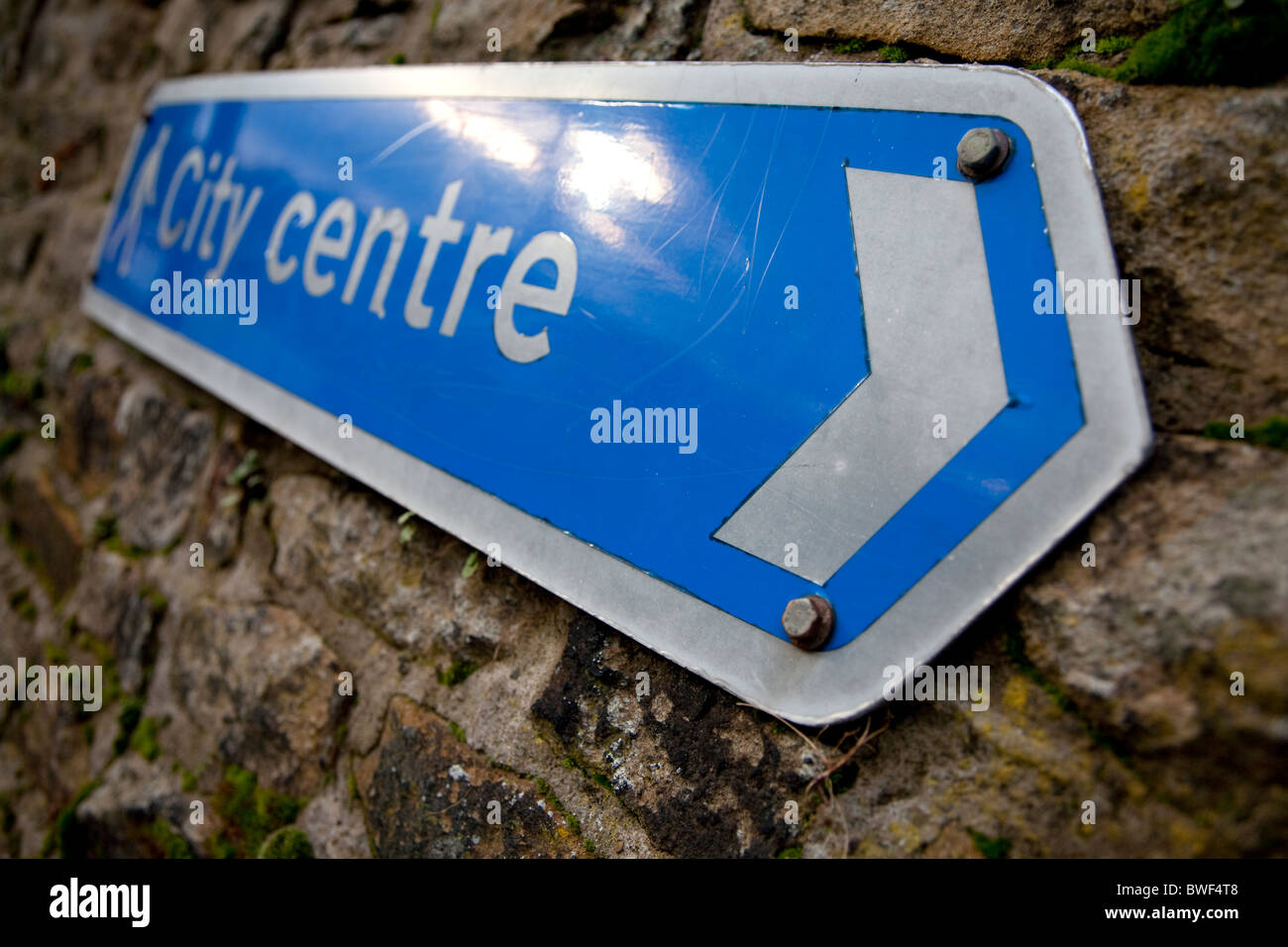 pedestrian sign in a city indicating the direction to the city centre ...