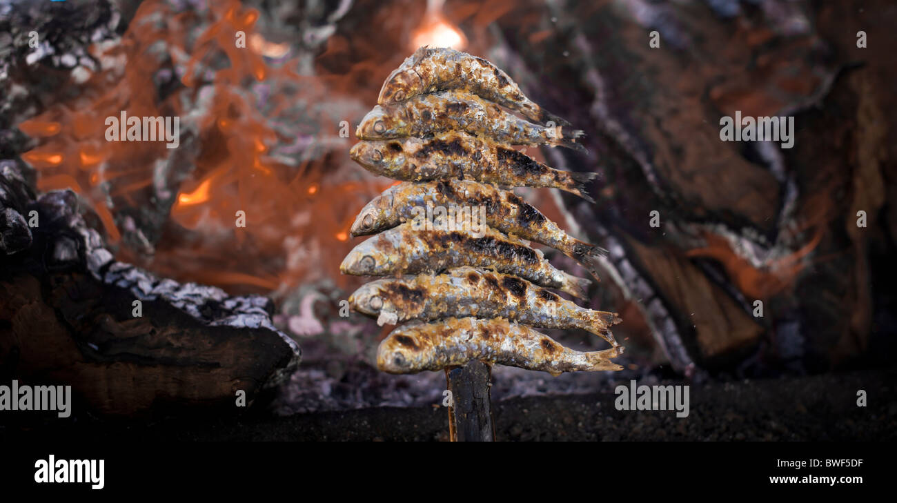 ESPETO ,FISH COOKED ON WOOD FIRE WITH WOODEN SKEWER Stock Photo - Alamy