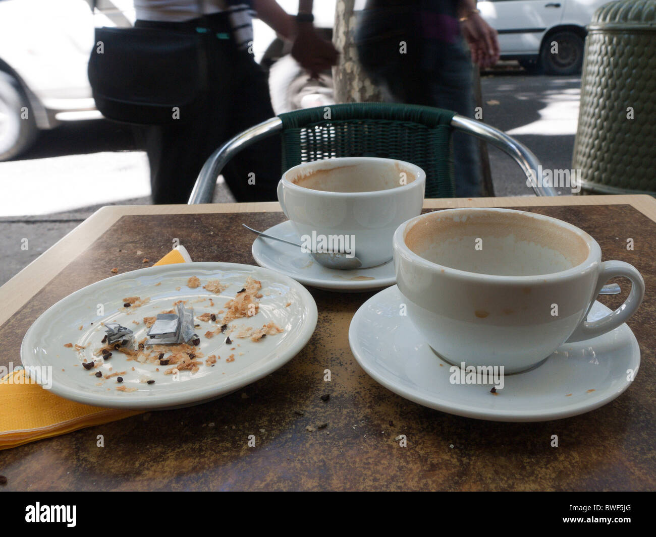 Empty coffee cups and croissant flakes on a plate after a sbnack break ...