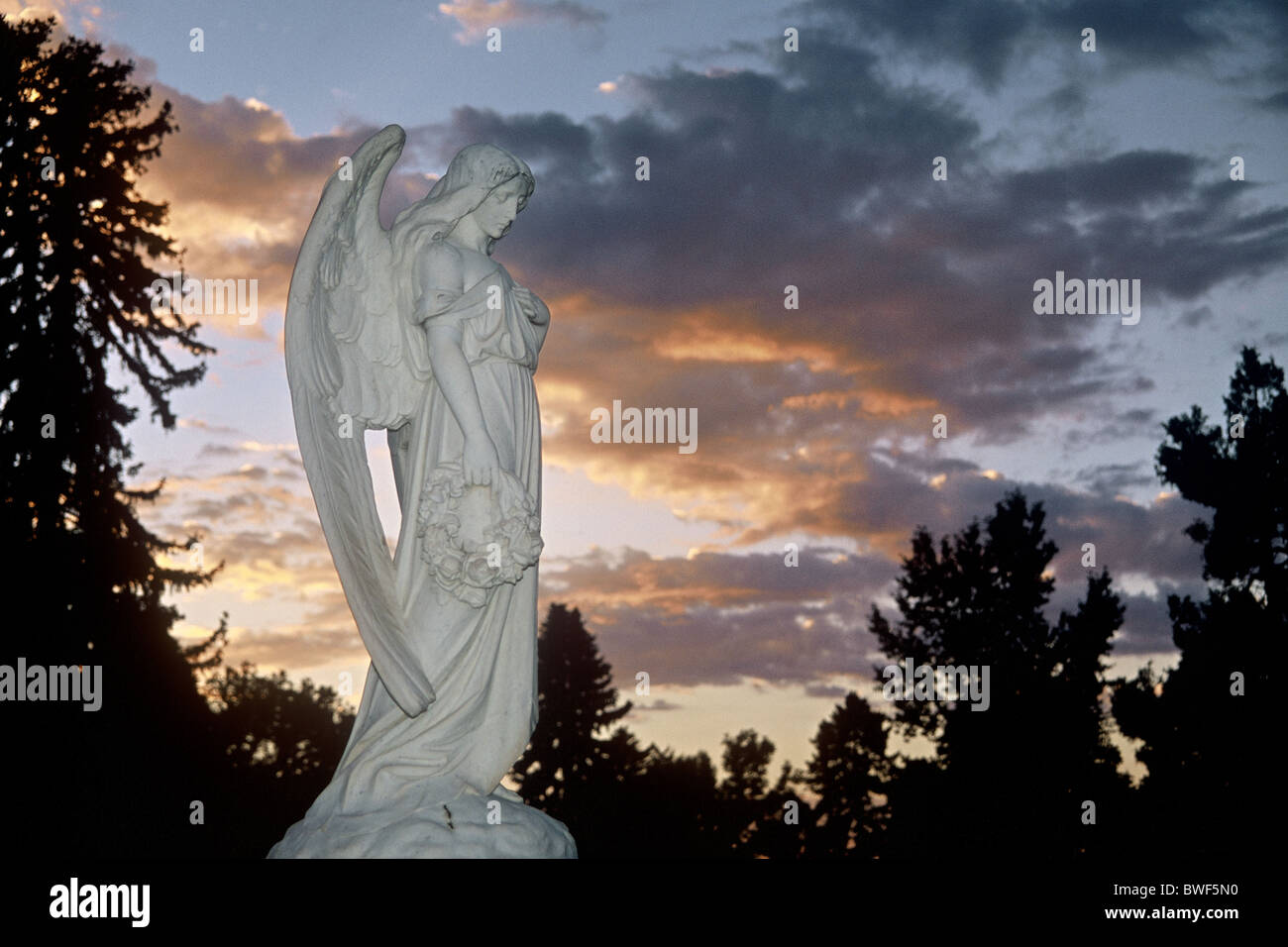 Angel statue at sunset Stock Photo - Alamy