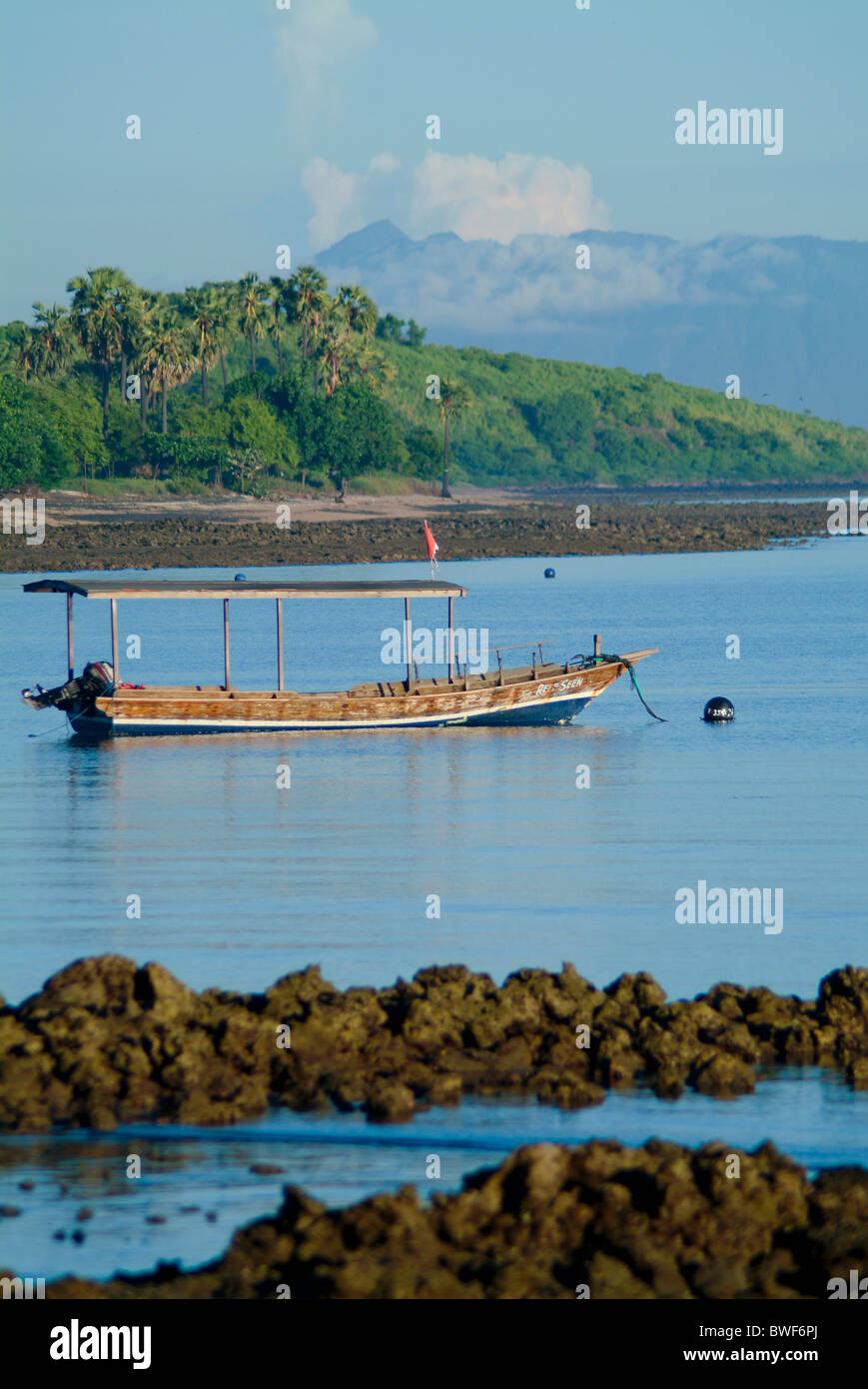 A dive boat waits anchored off the coast of northwest Bali in the ...