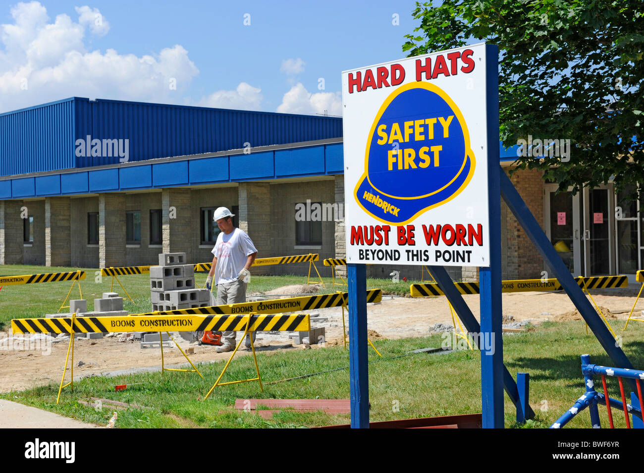 Construction Area with warning signs about safety and hard hats ...