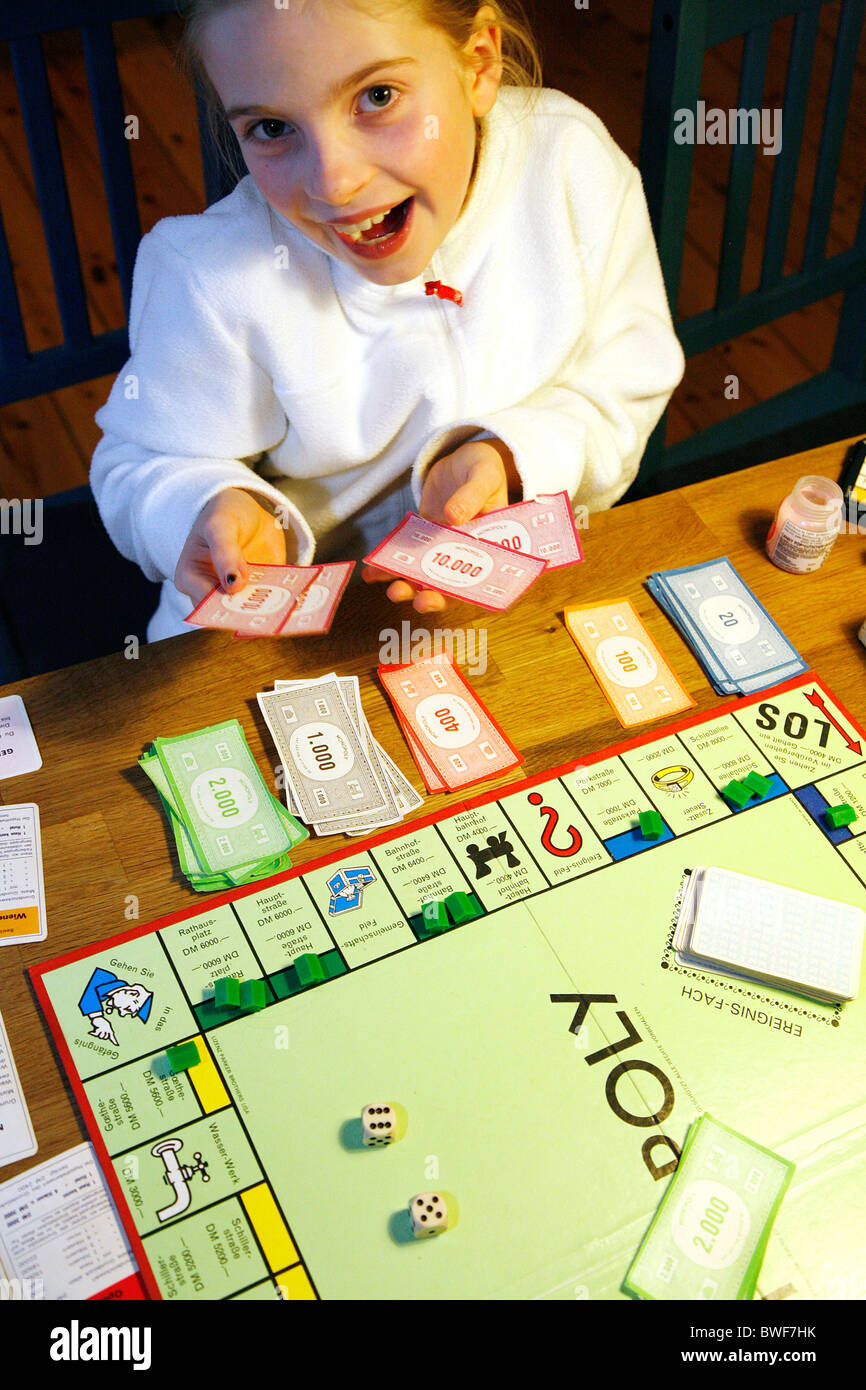 Girl playing Monopoly Stock Photo - Alamy