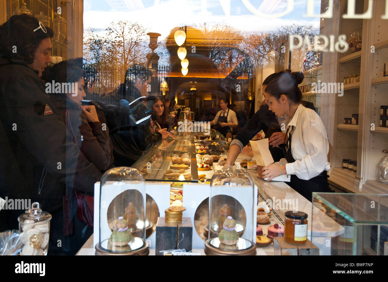 Reflection on a traditional French patisserie window, Champ Elysee ...